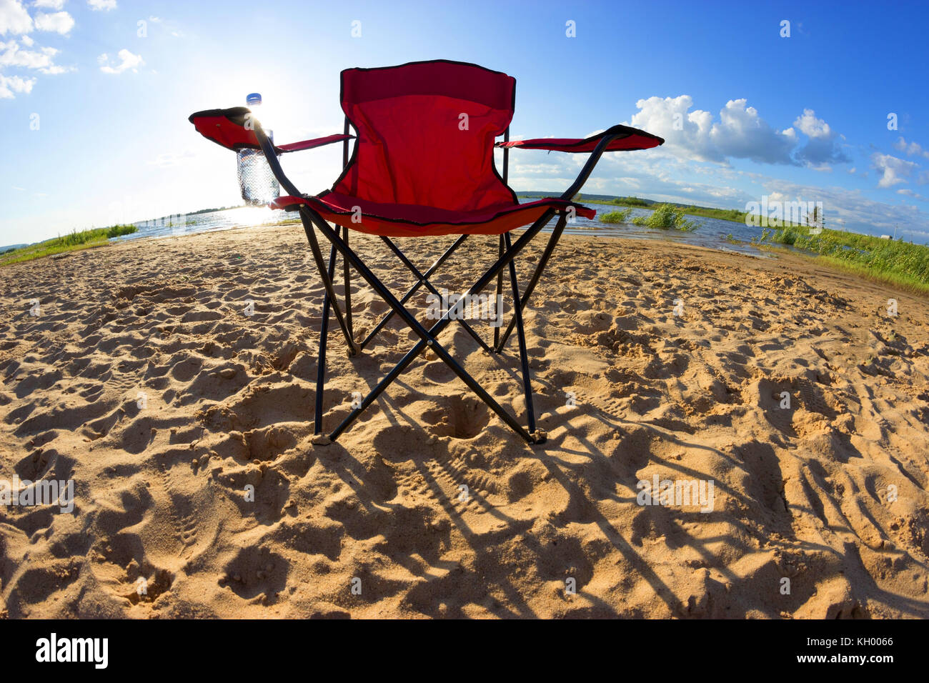 red beach chair on the beach. sunny day Stock Photo - Alamy