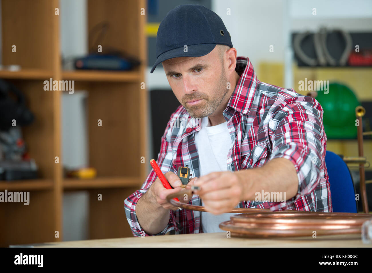 plumber marking copper pipe Stock Photo - Alamy