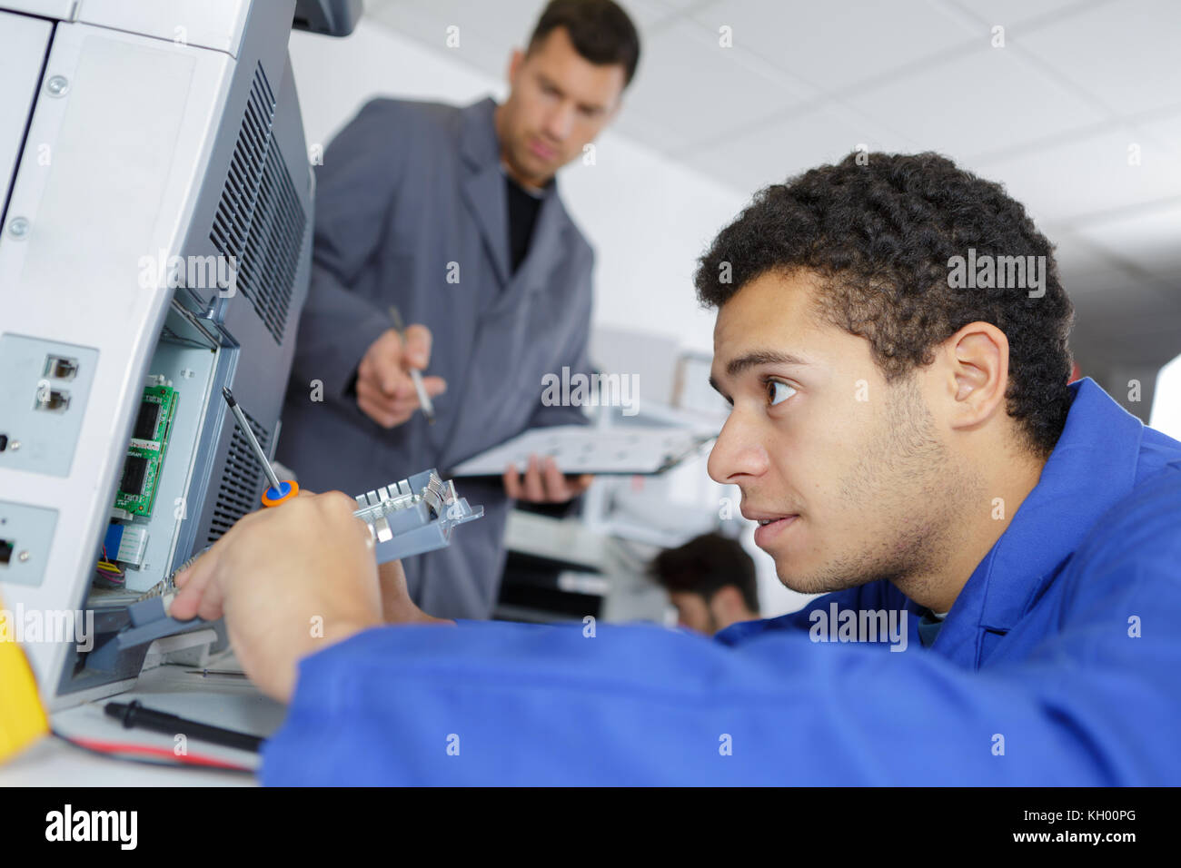 apprentice technician repairing a printer at business place at work ...