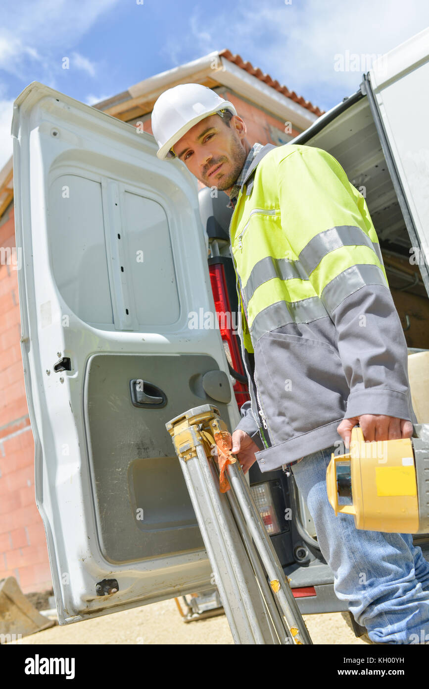 industrial worker posing next to a utility van Stock Photo - Alamy