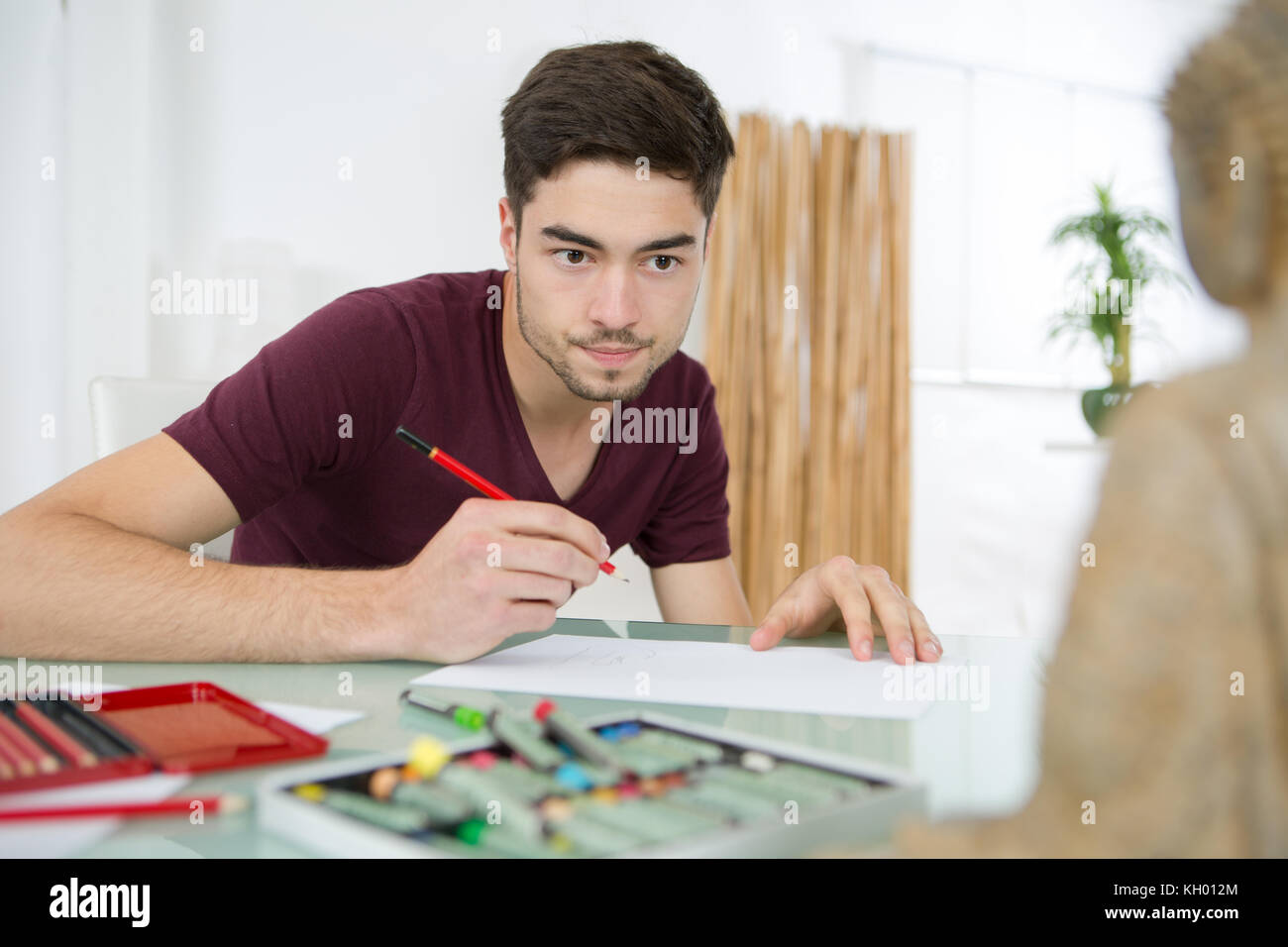 young man drawing pictures in studio Stock Photo - Alamy