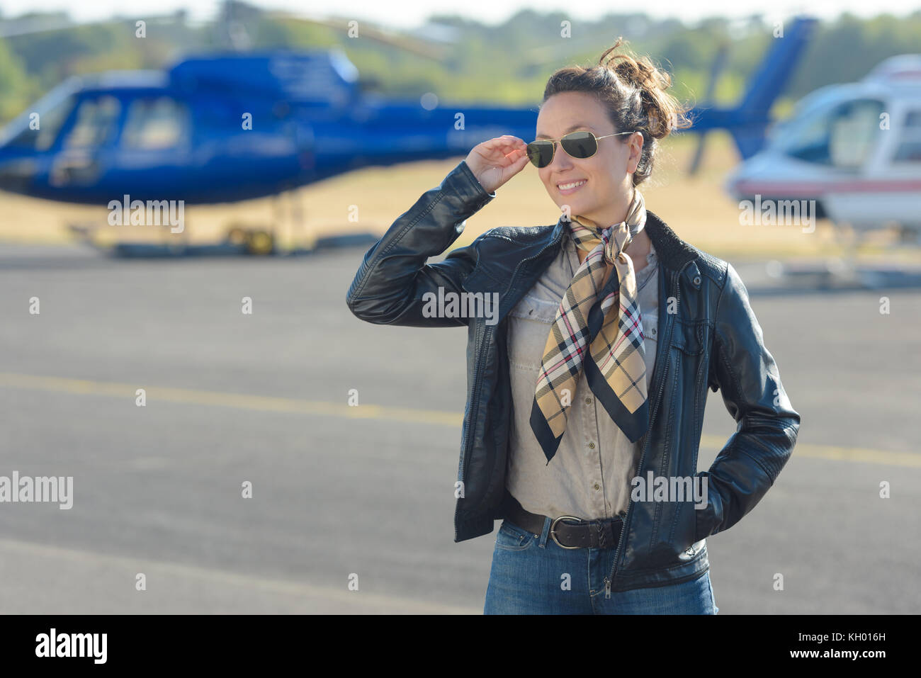 pretty pilot woman on helicopter background Stock Photo - Alamy