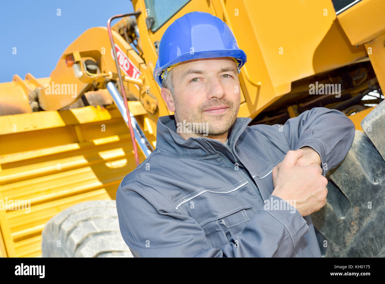 Portrait of man next to heavy plant machinery Stock Photo - Alamy