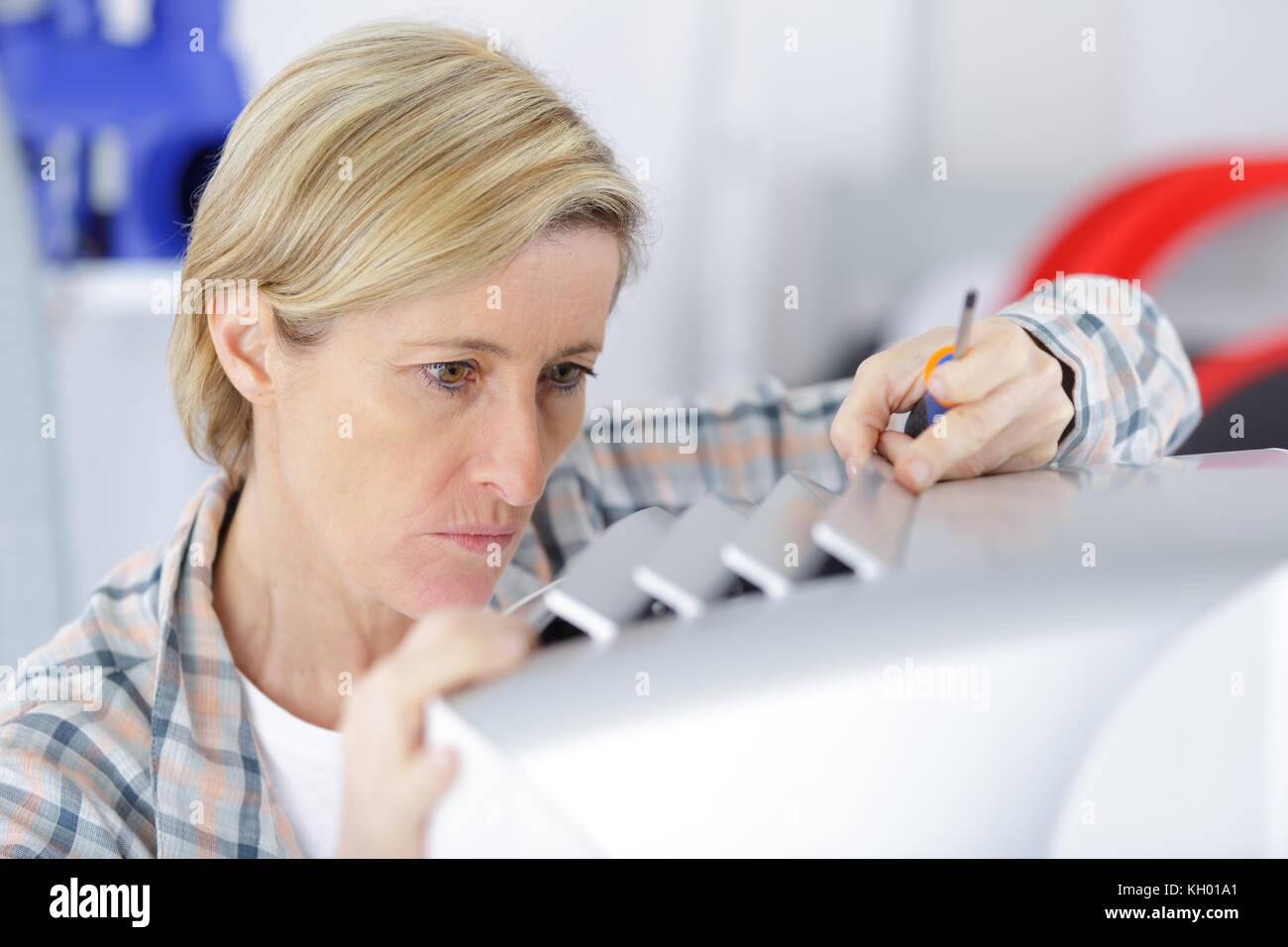 woman fixing an appliance Stock Photo - Alamy