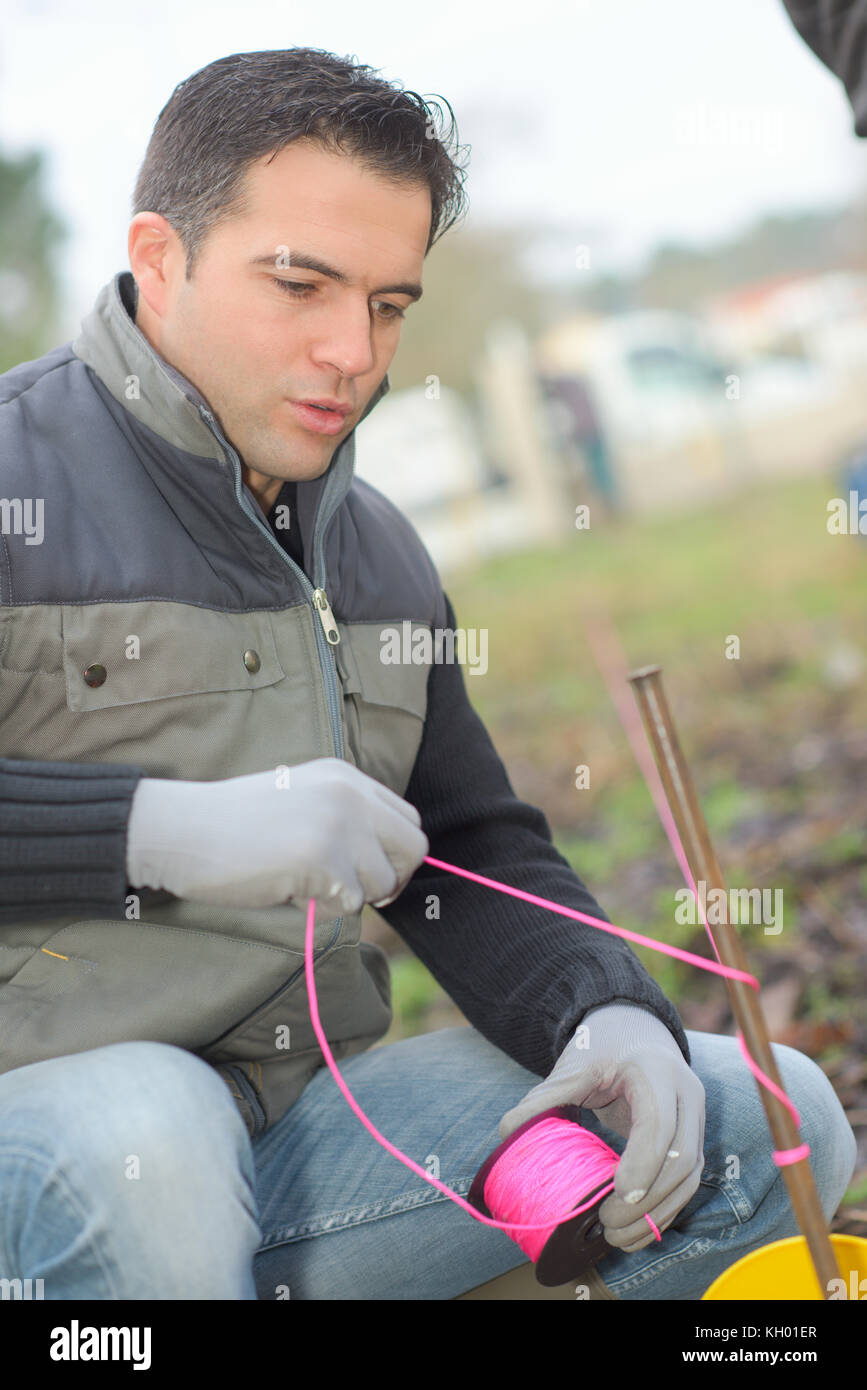 digging a trench with the aid of a string line Stock Photo - Alamy