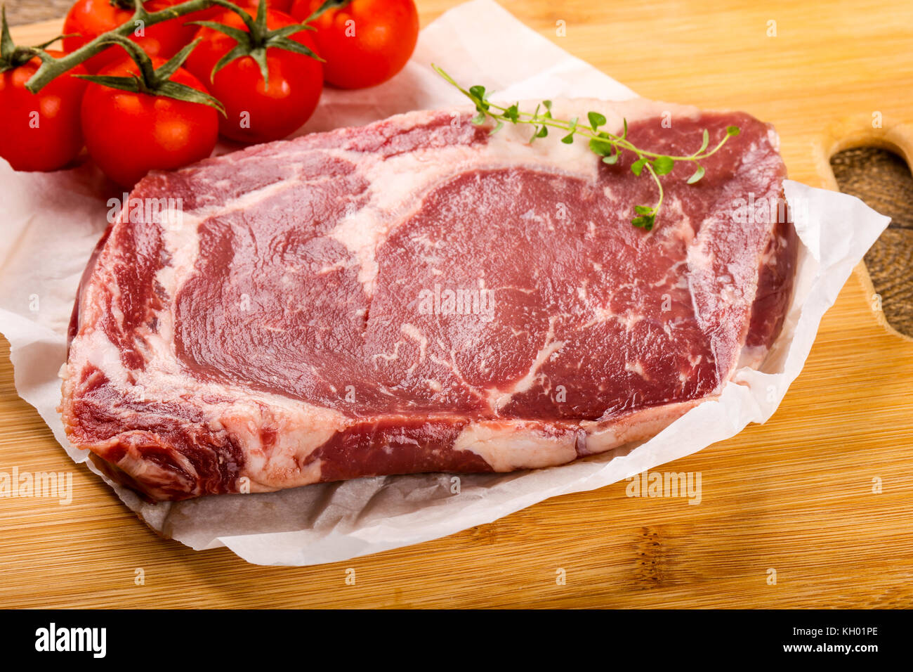 Raw ribeye steak with thyme - ready for cooking Stock Photo - Alamy