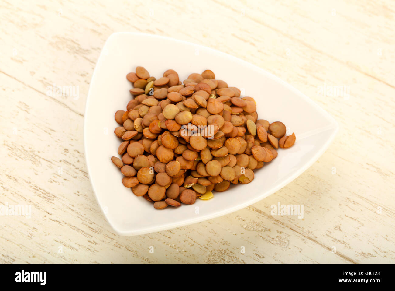 Raw lentils in the bowl ready for cooking Stock Photo - Alamy