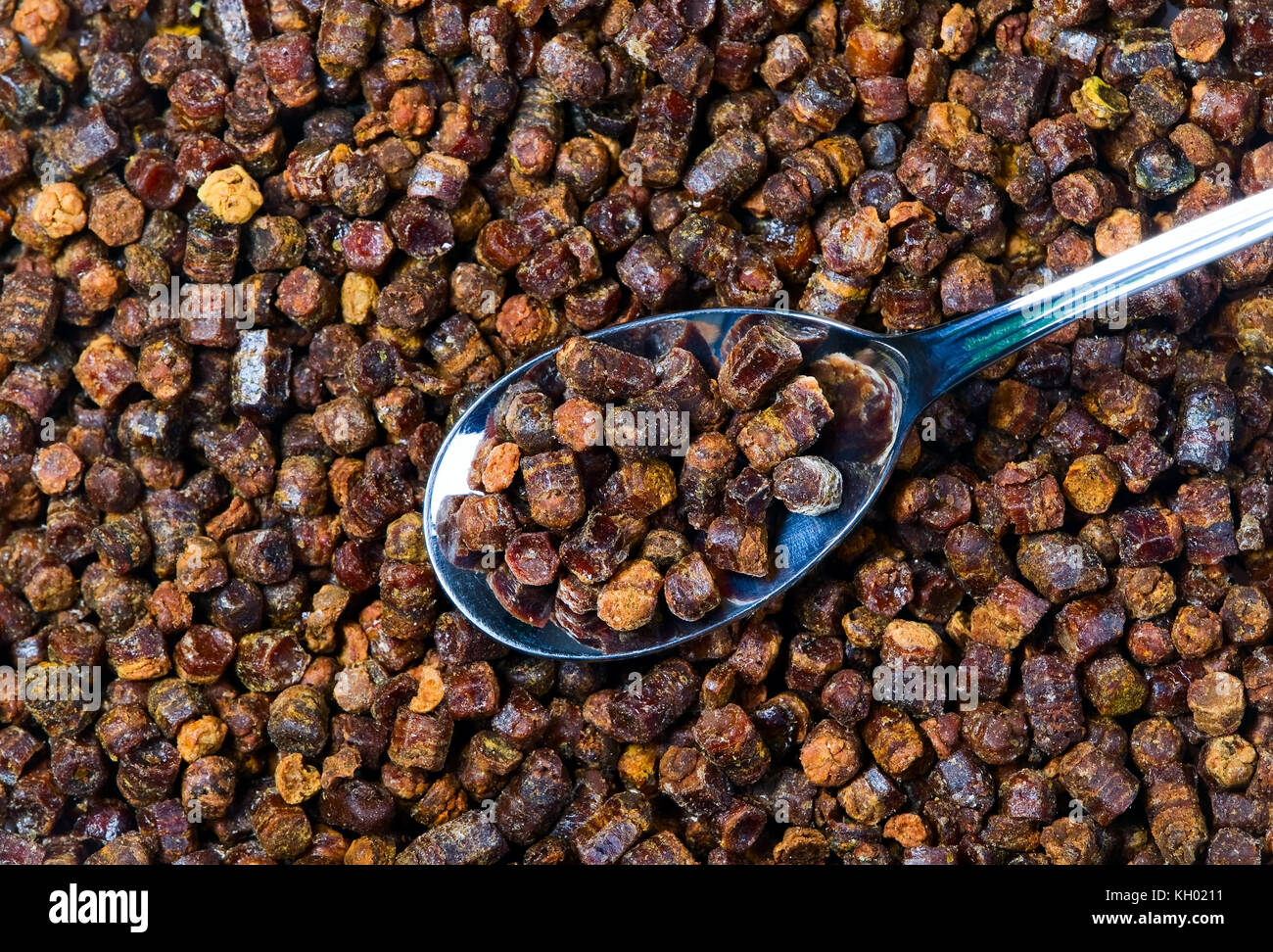 Propolis granules background with spoon inside, bee product Stock Photo ...