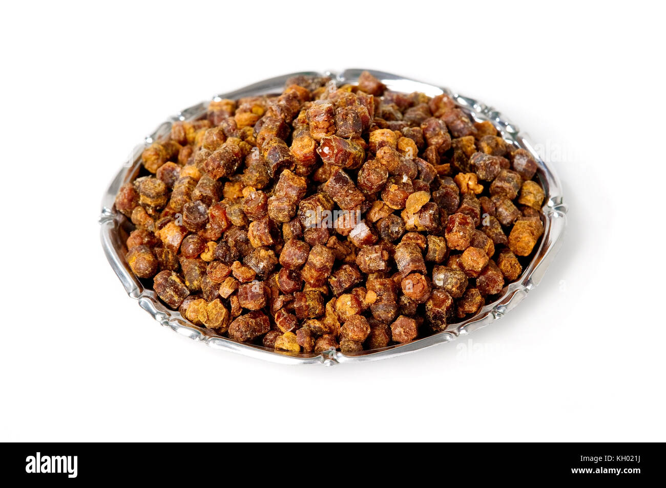 Propolis granules inside plate on background, bee product Stock Photo ...