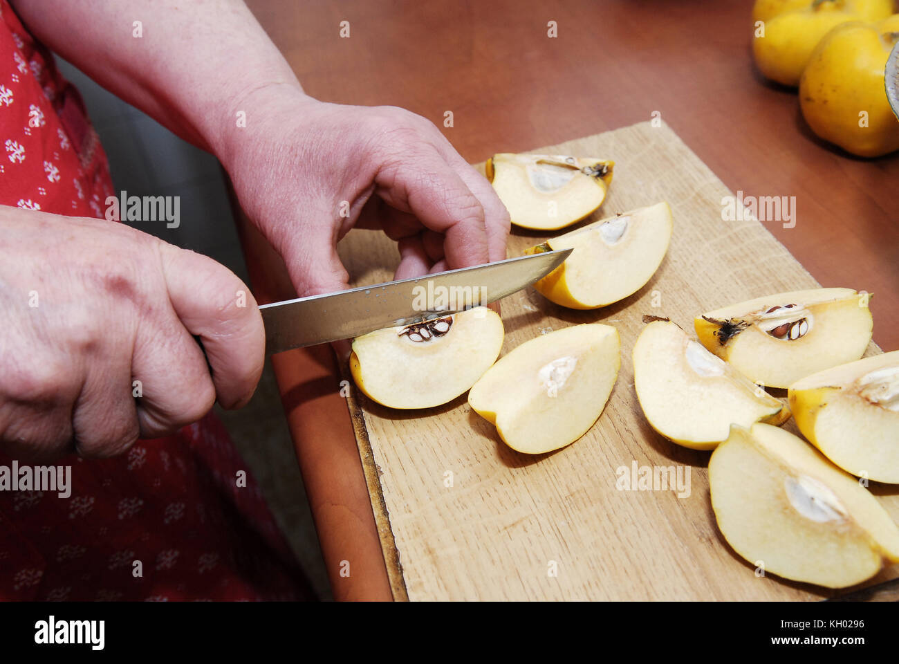 Cutting quince with knife Stock Photo - Alamy
