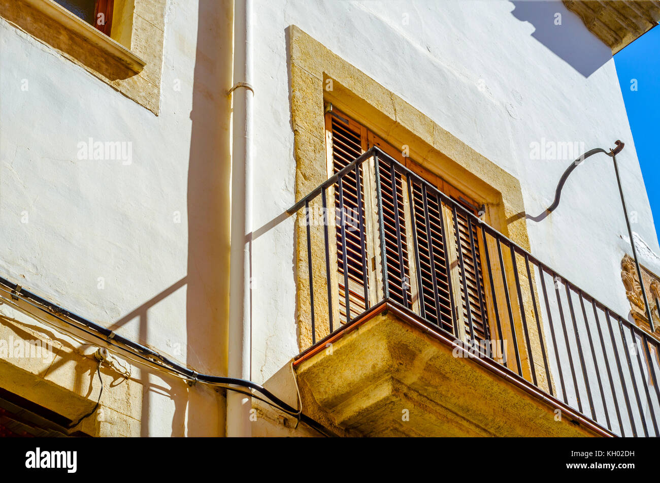 Stylish balcony with a metal railing, solid architectural element, a ...
