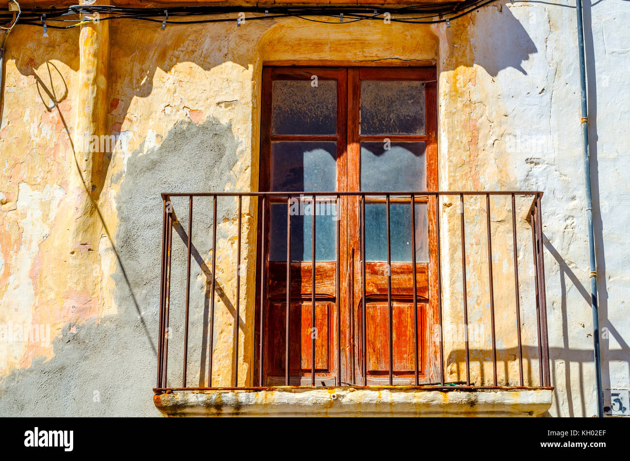 Stylish balcony with a metal railing, solid architectural element, a ...