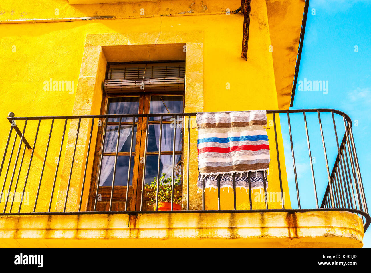 Stylish balcony with a metal railing, solid architectural element, a ...