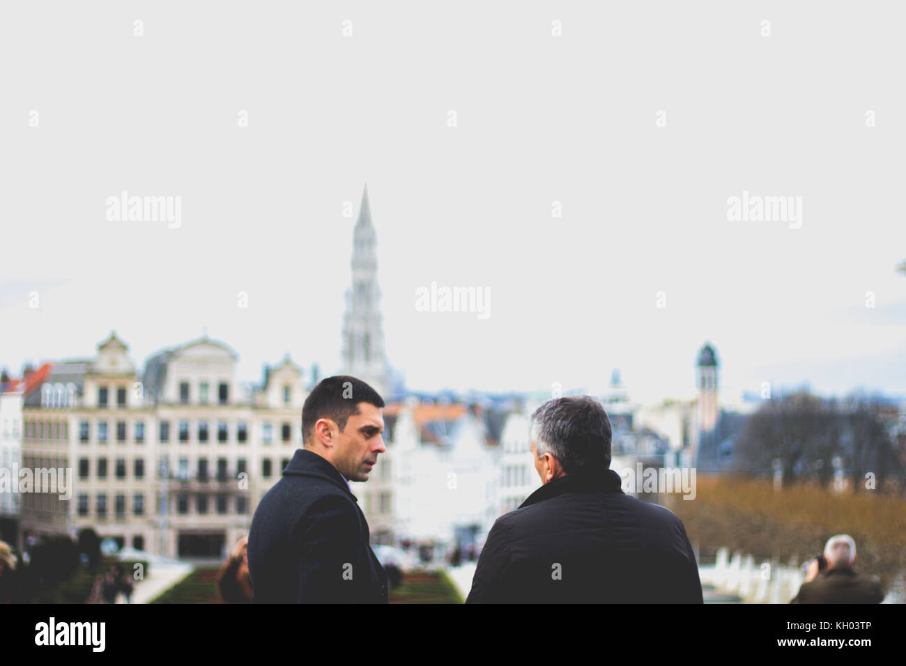 two men dressed in business attire suits talking Stock Photo - Alamy