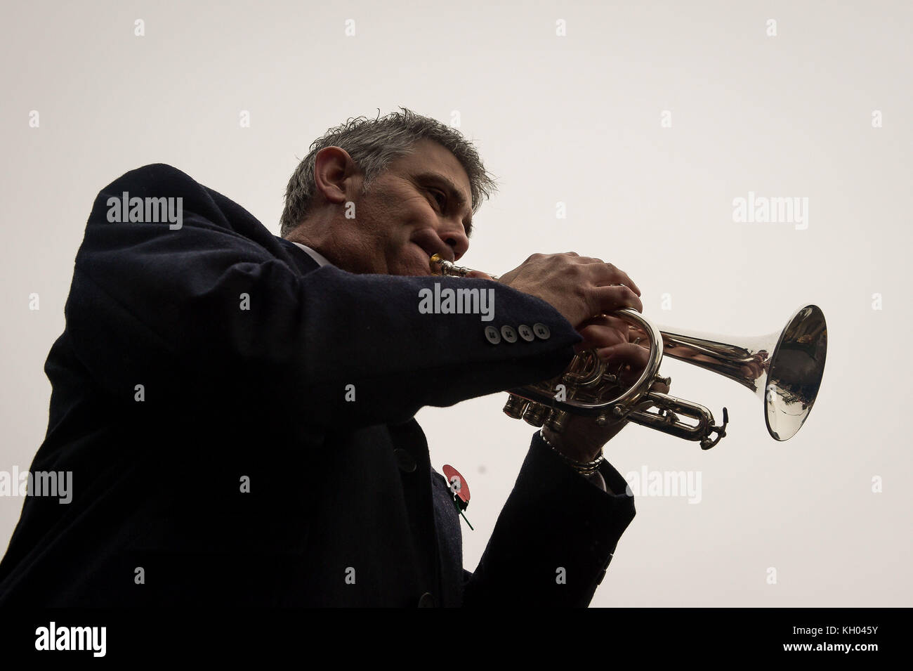 A bugler plays the last post to start the silence during a service of ...