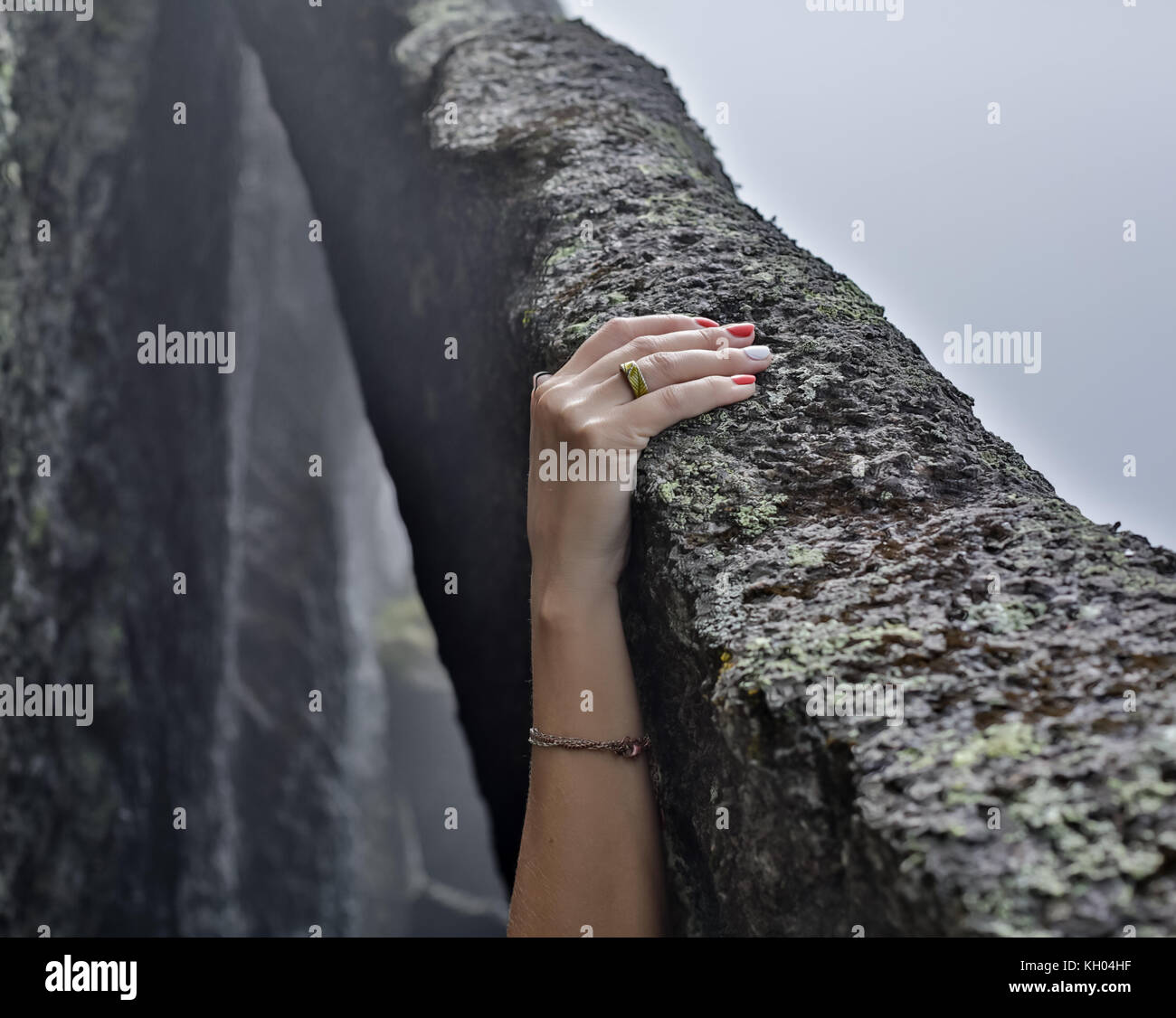 young woman rock climber hands climbing at seaside mountain cliff rock ...