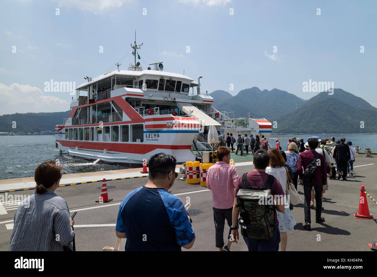 Hiroshima, Japan - May 26, 2017: Tourists embark on the ferry at port ...