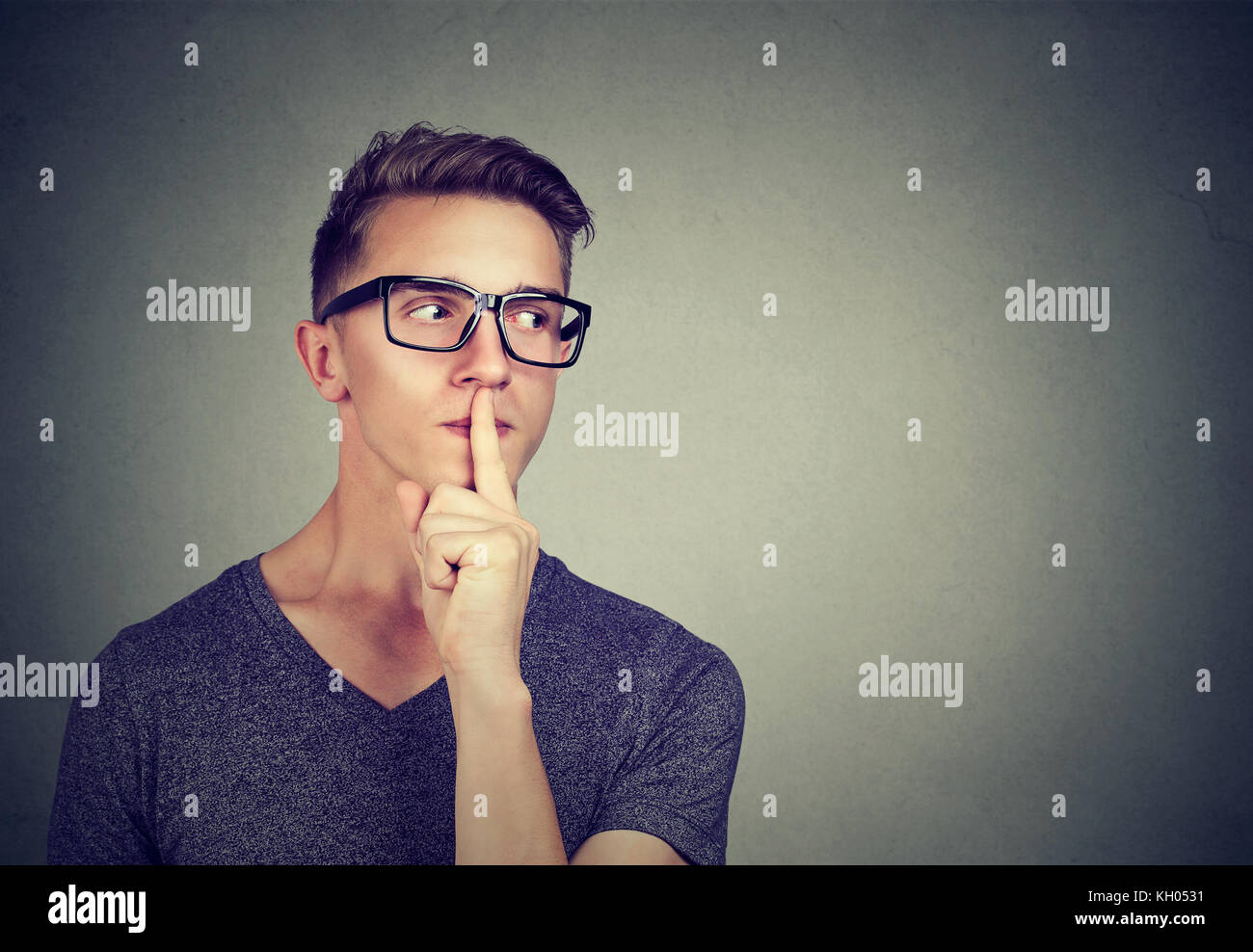 Secret guy. Man saying hush be quiet with finger on lips gesture ...