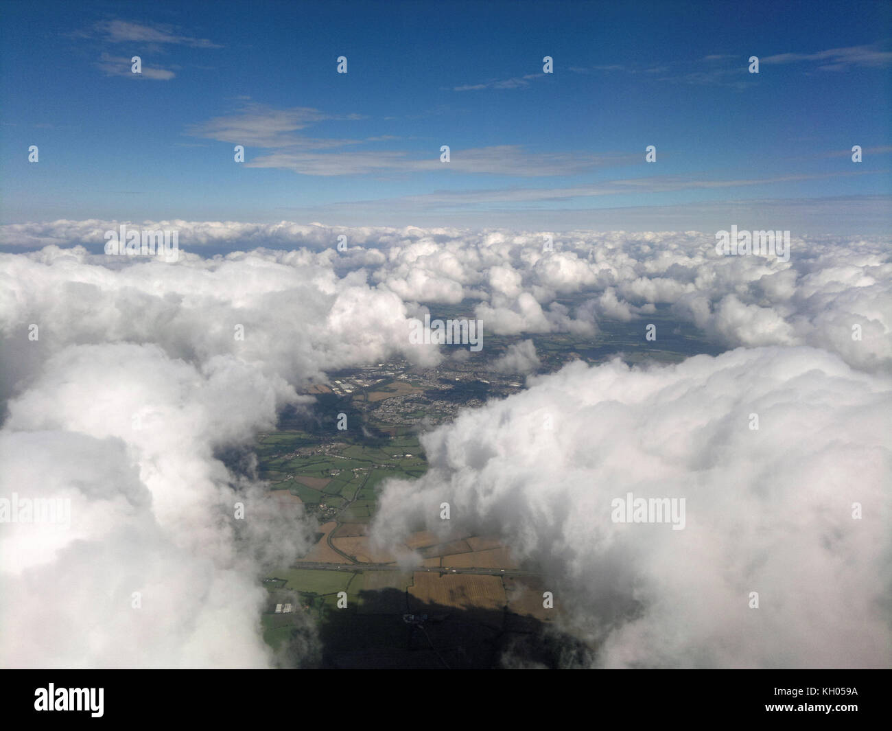 Above the sky. Flying over clouds in plane Stock Photo - Alamy