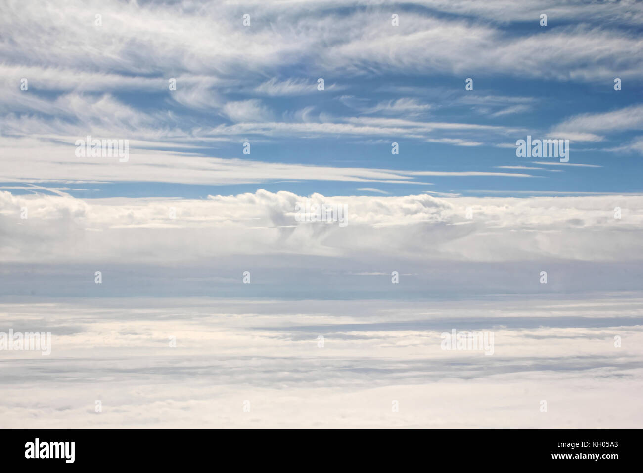 Above the sky. Flying over clouds in plane Stock Photo - Alamy