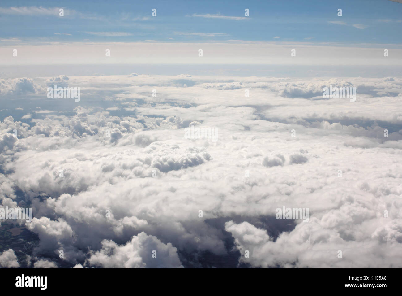 Above the sky. Flying over clouds in plane Stock Photo - Alamy