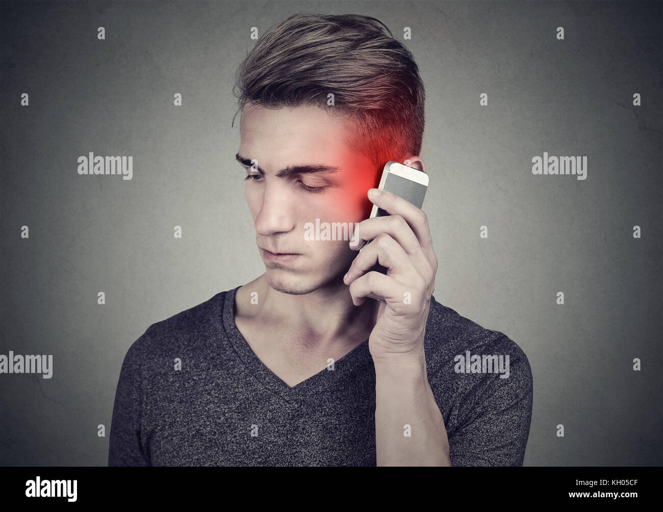 Man on the cellphone with headache. Upset unhappy guy talking on a ...
