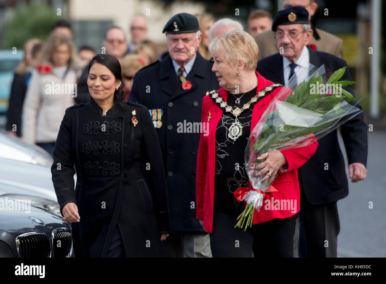 Priti Patel (left) walks with the mayor of Witham JoAnn Williams ...