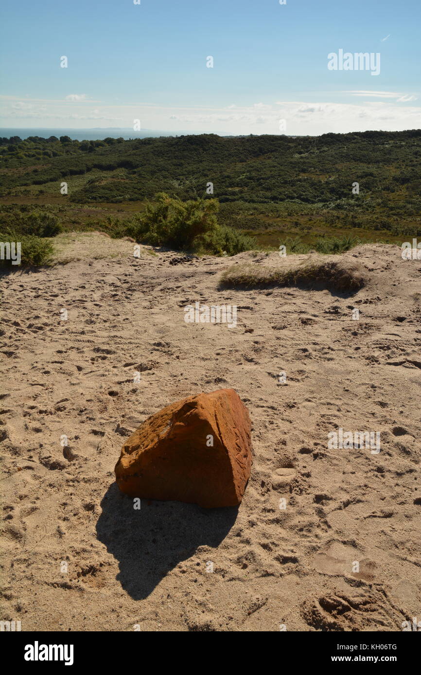 Rock on sand Stock Photo - Alamy