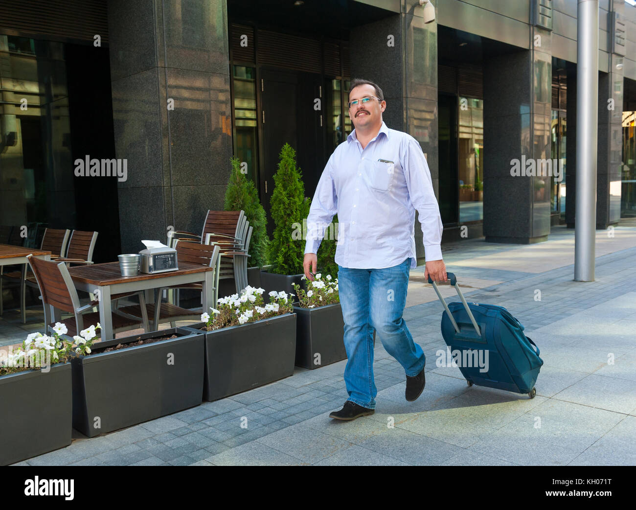 Middle age manager walking Stock Photo - Alamy