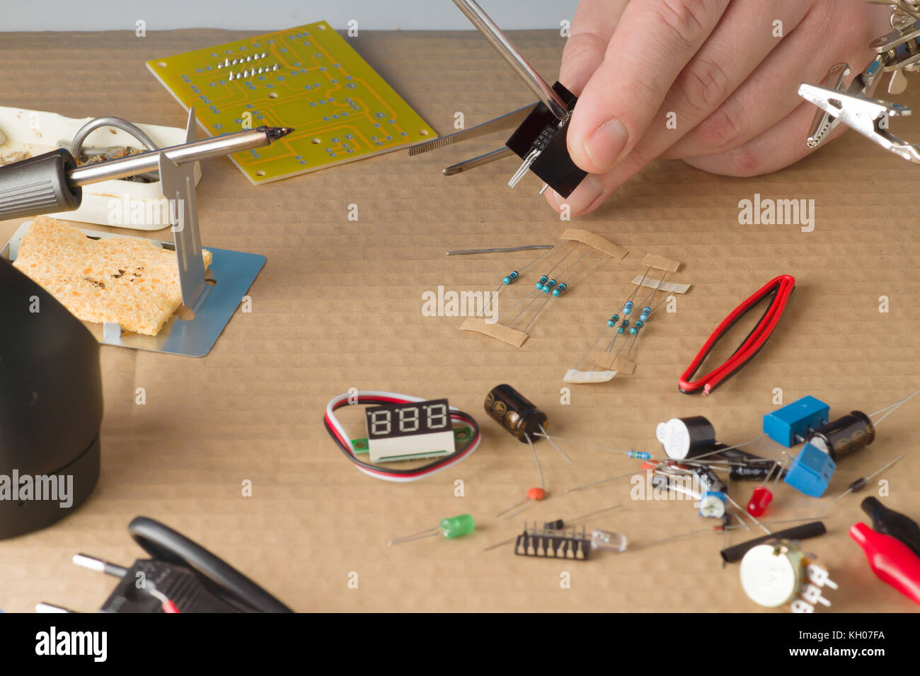 master repairs electronic equipment at his workplace Stock Photo - Alamy