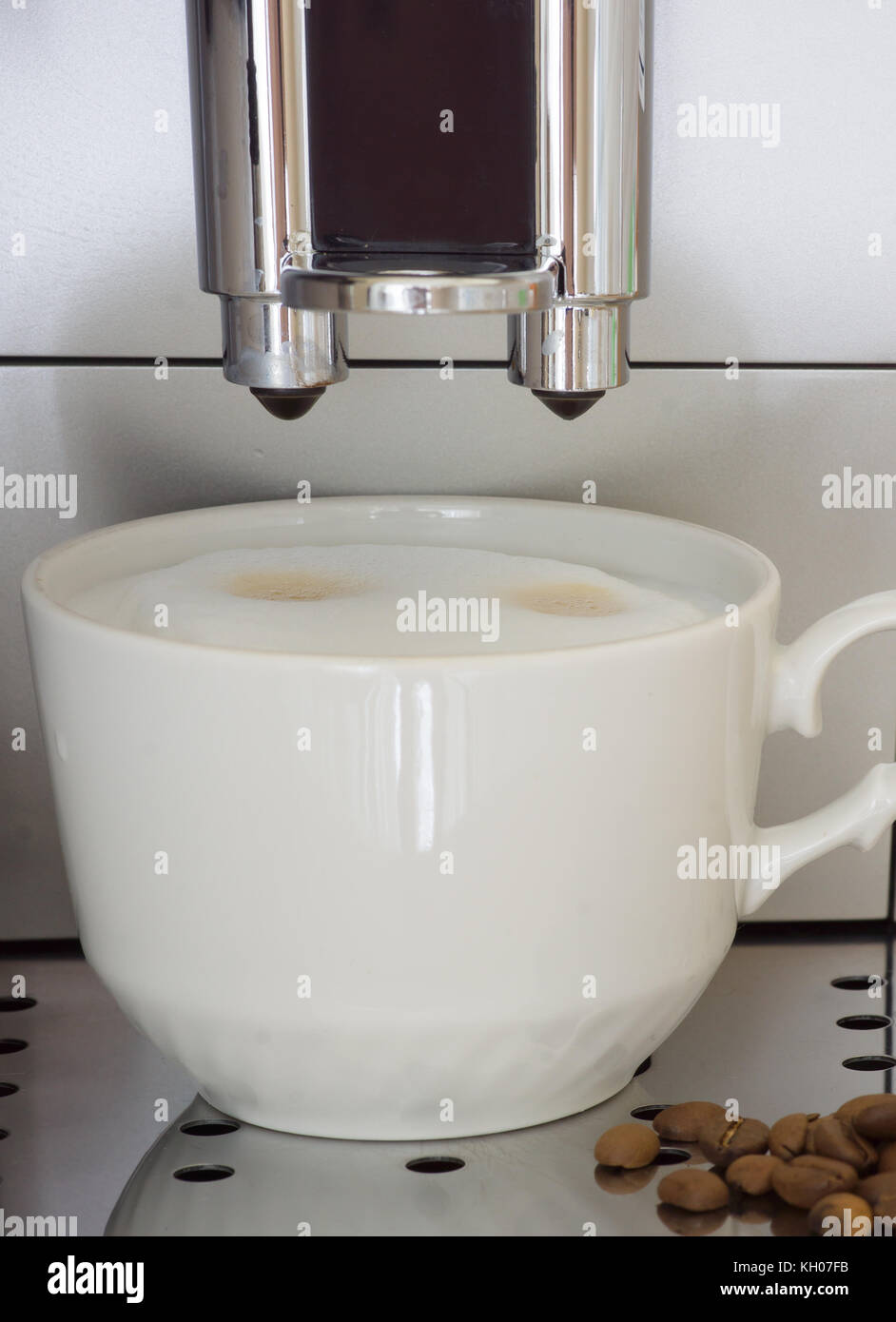 The coffee machine brews coffee and pours it into mugs Stock Photo - Alamy