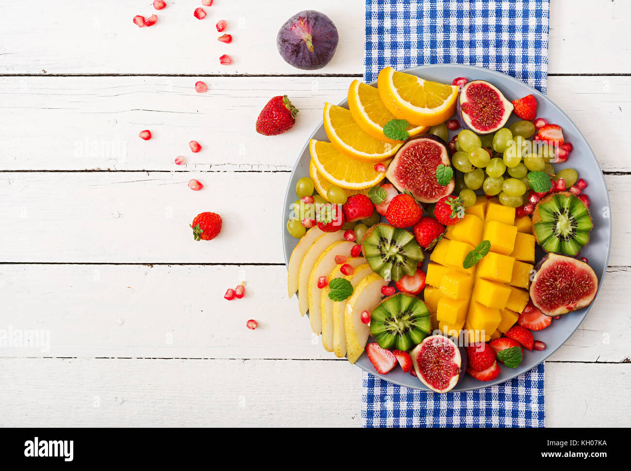 Platter fruits and berries. Mango, kiwi, fig, strawberry, grapes, pear ...