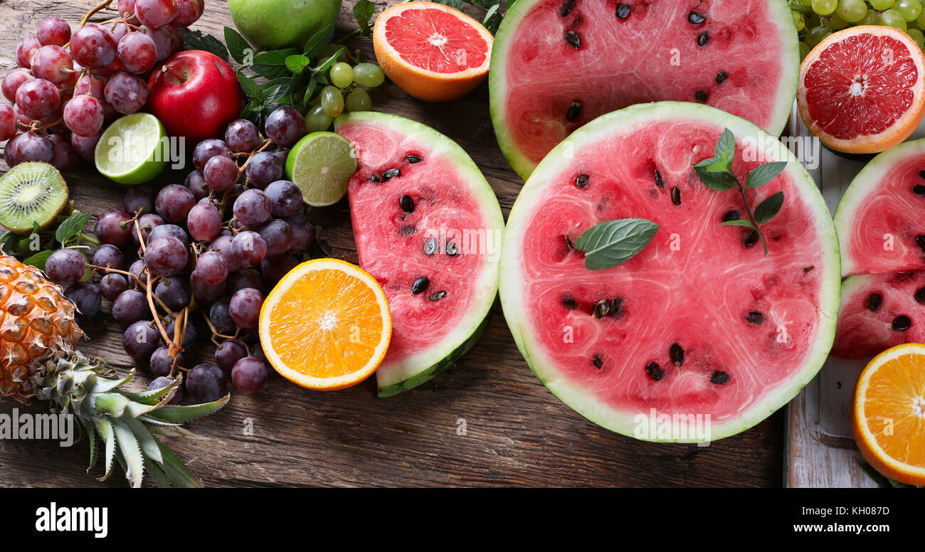 Slices of watermelon with fresh fruits on wooden background. Panorama ...