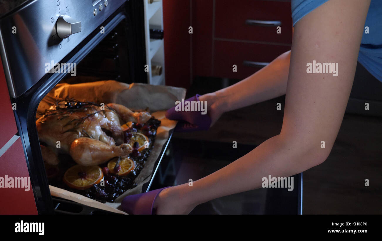 Female Hands Take Out Roasted Whole Chicken on tray From Hot Oven Stock ...