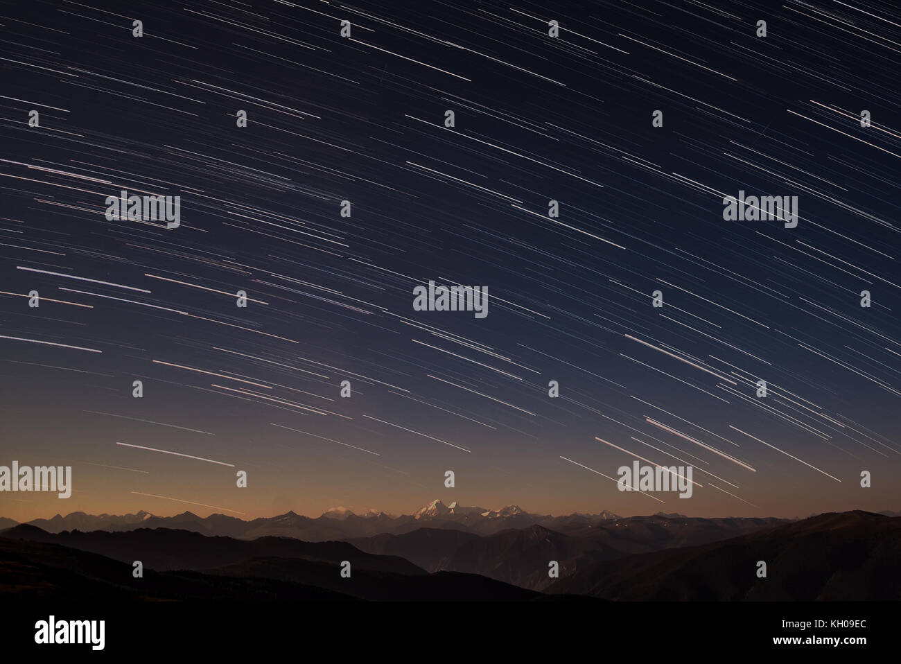 Beautiful night landscape with traces of stars in the form of tracks in ...