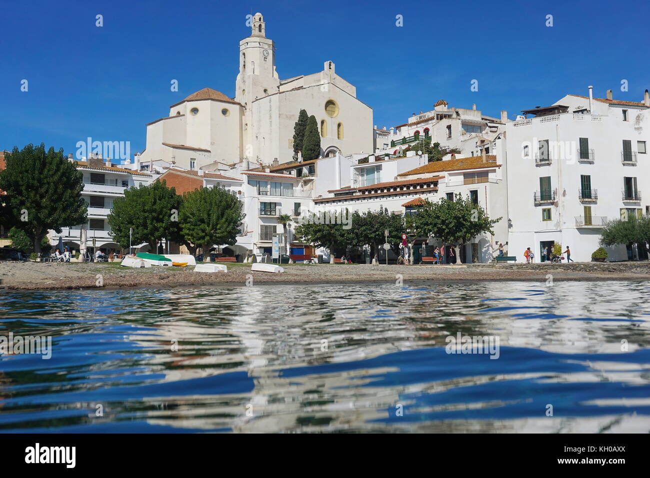 Spain Costa Brava village of Cadaques, houses and a church on the shore ...