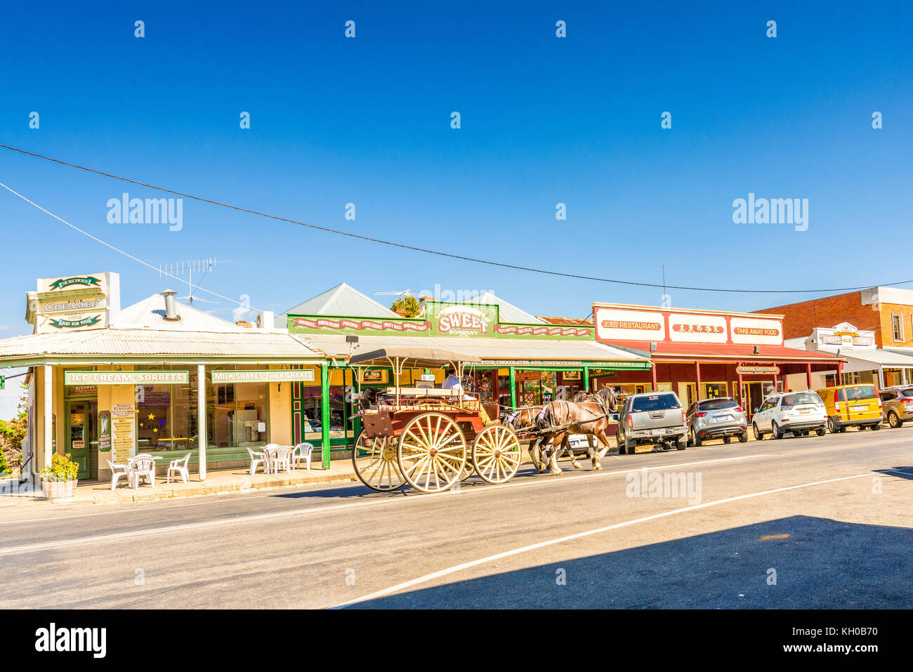 A cart and horses on the main street in the historic town of Beechworth ...