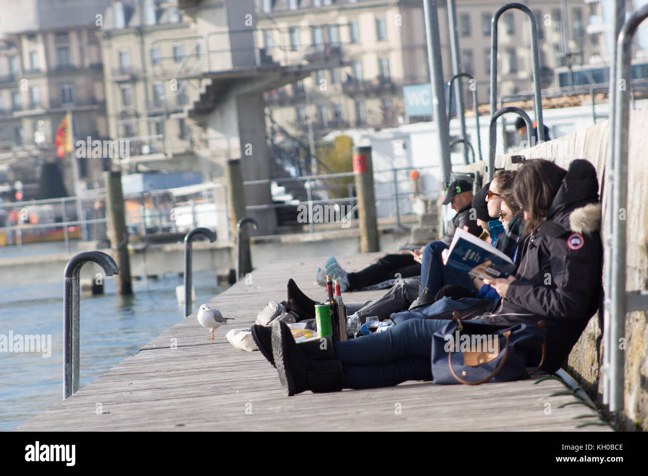 People eating and drinking by water Stock Photo - Alamy