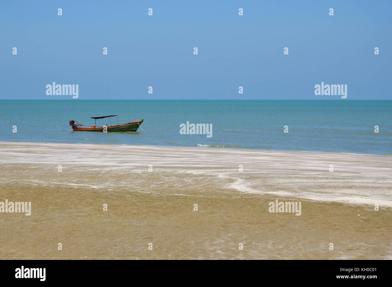fishery boat floating on beach in sunny day Stock Photo - Alamy
