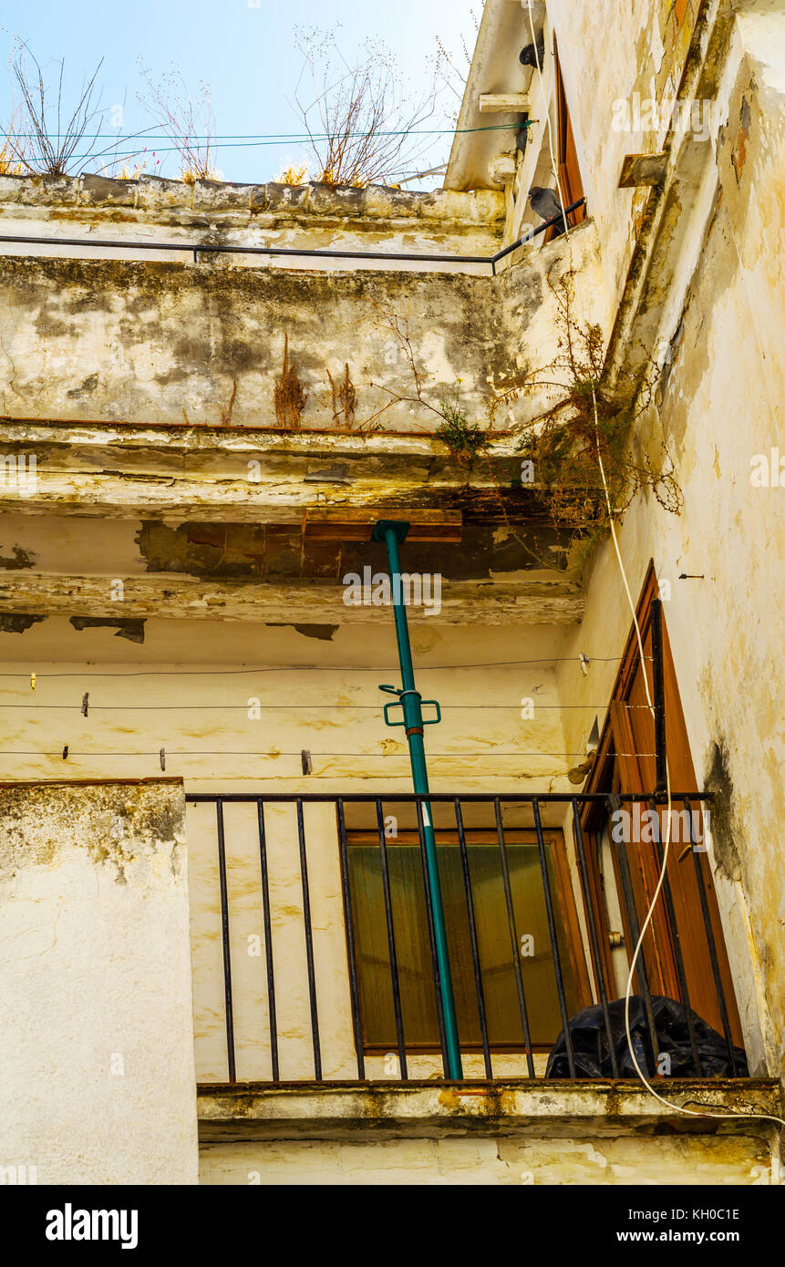 Stylish balcony with a metal railing, solid architectural element, a ...