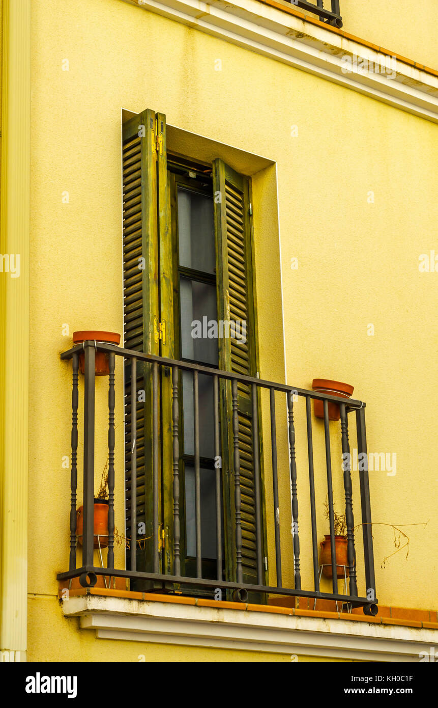 Stylish balcony with a metal railing, solid architectural element, a ...