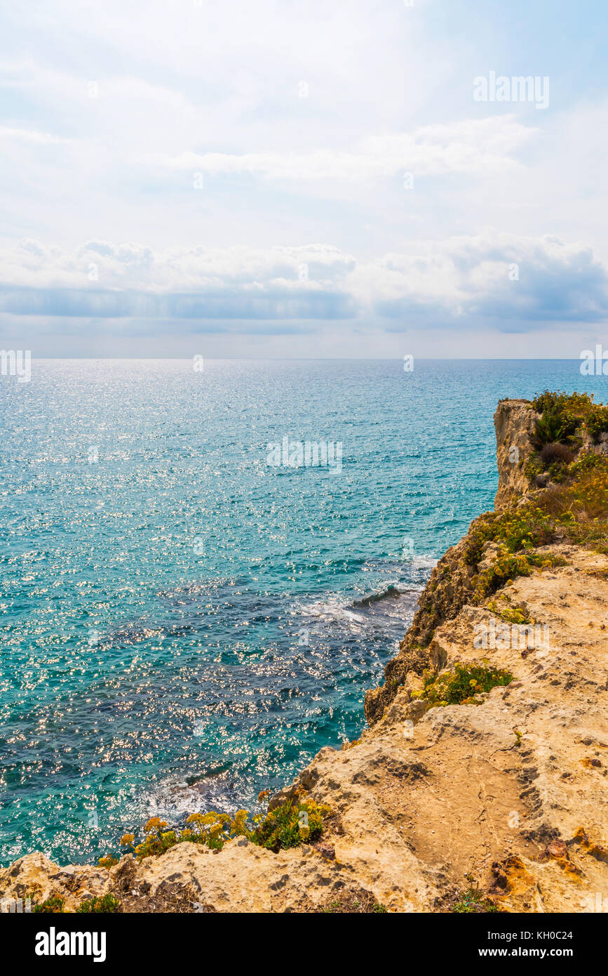 high cliff above the sea, summer sea background, many splashing waves ...