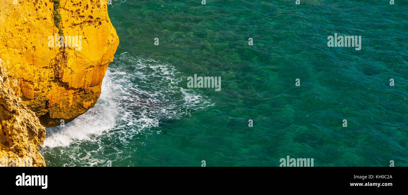 high cliff above the sea, summer sea background, many splashing waves ...