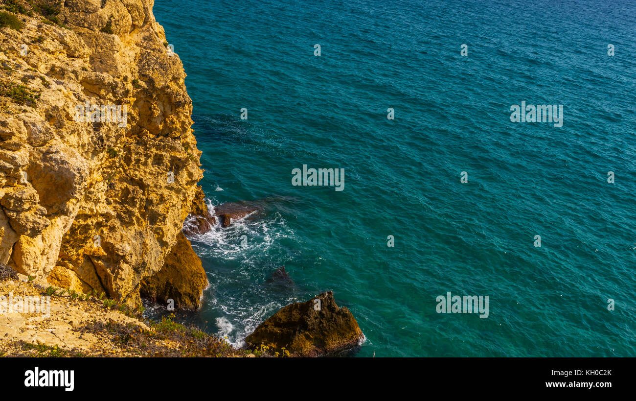 high cliff above the sea, summer sea background, many splashing waves ...