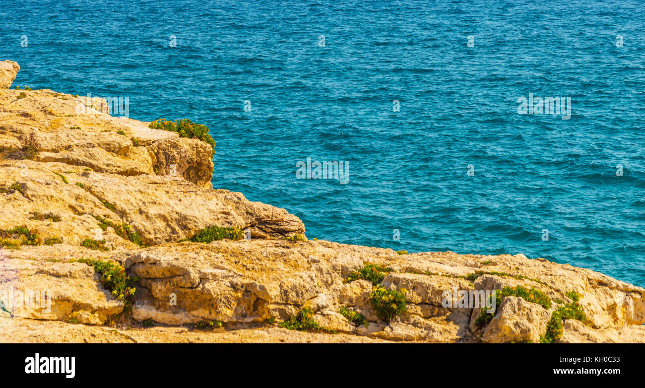 high cliff above the sea, summer sea background, many splashing waves ...