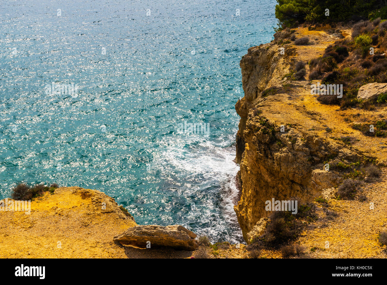 high cliff above the sea, summer sea background, many splashing waves ...