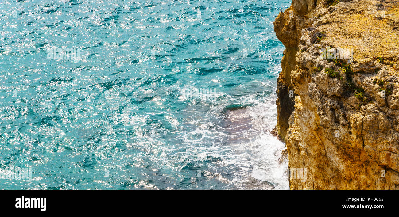 high cliff above the sea, summer sea background, many splashing waves ...