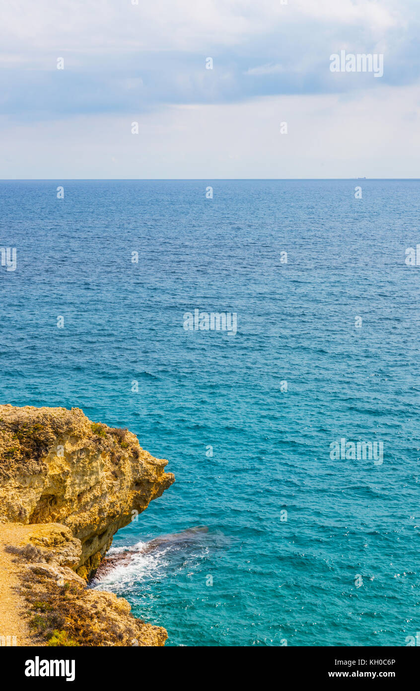high cliff above the sea, summer sea background, many splashing waves ...