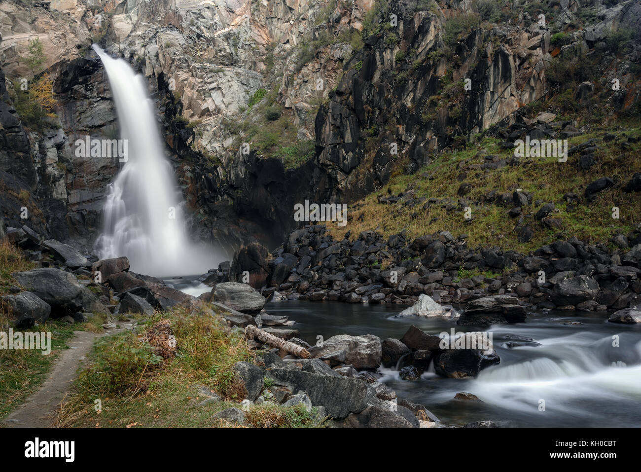Beautiful view of the waterfall with smooth water falling among the ...