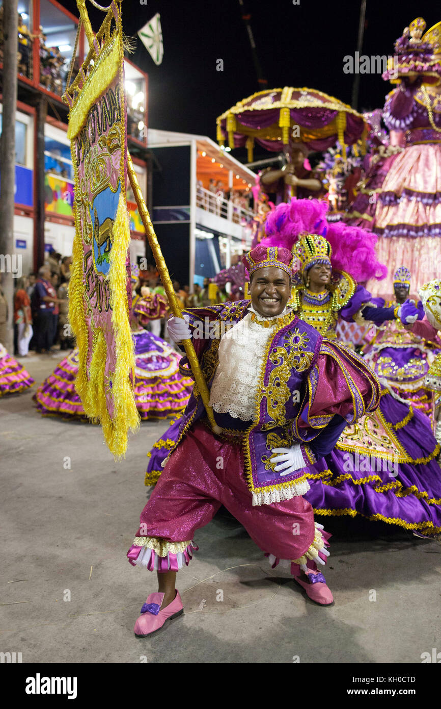 A proud Império de Tijuca samba school member holds up the school’s ...